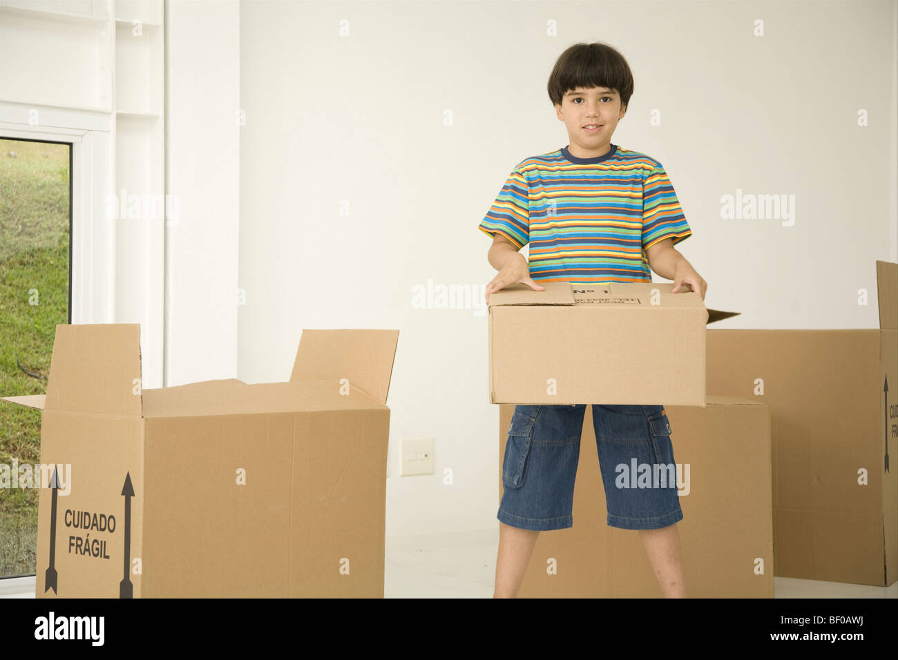 Boy holding a cardboard box Stock Photo - Alamy