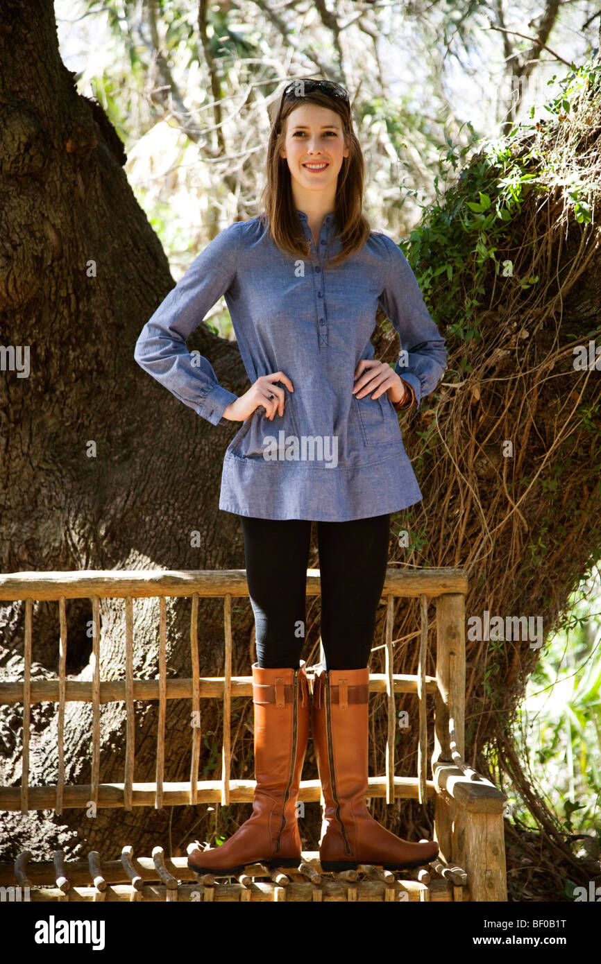Woman wearing boots and standing on a bench Stock Photo - Alamy