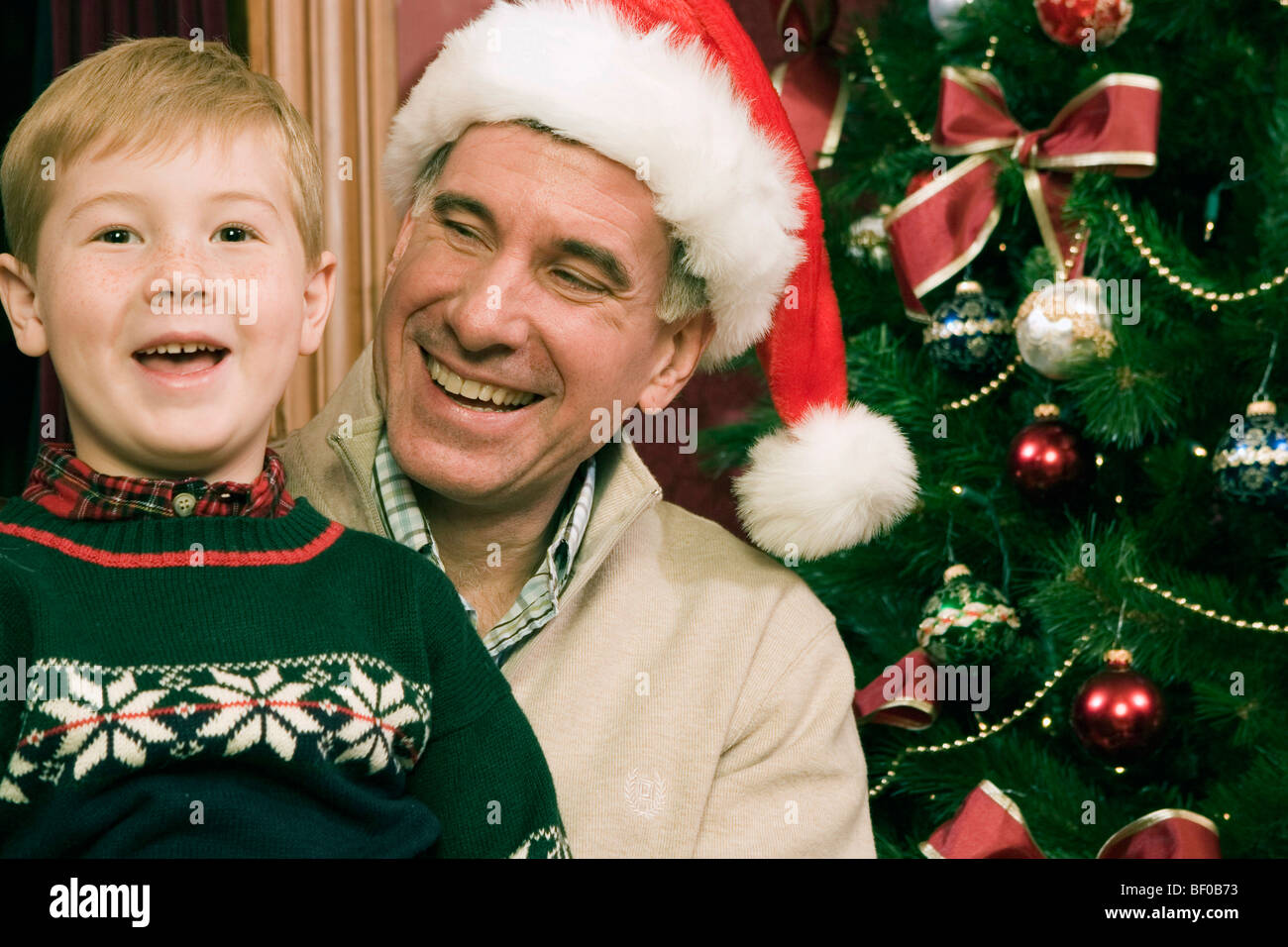 Portrait of a boy and his grandfather smiling Stock Photo - Alamy