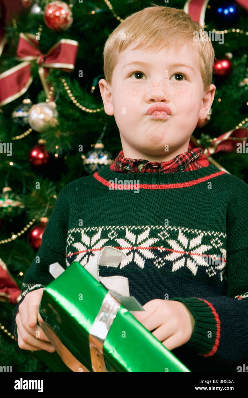 Boy opening a Christmas present Stock Photo - Alamy