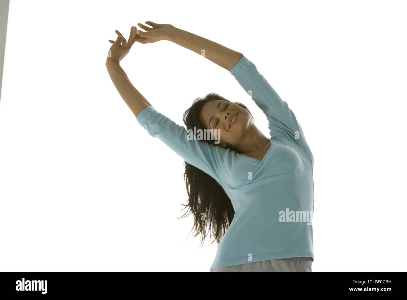 Young woman stretching her arms above her head Stock Photo - Alamy Young woman stretching her arms above her head Stock Photo - Alamy