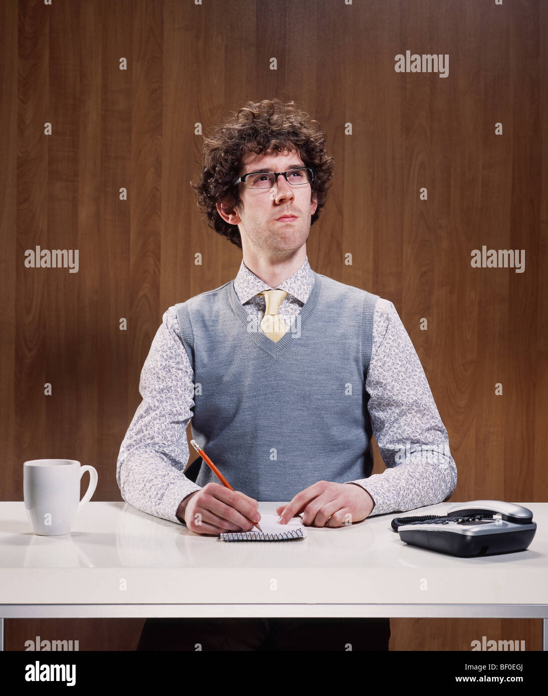 Serious businessman writing notes Stock Photo - Alamy