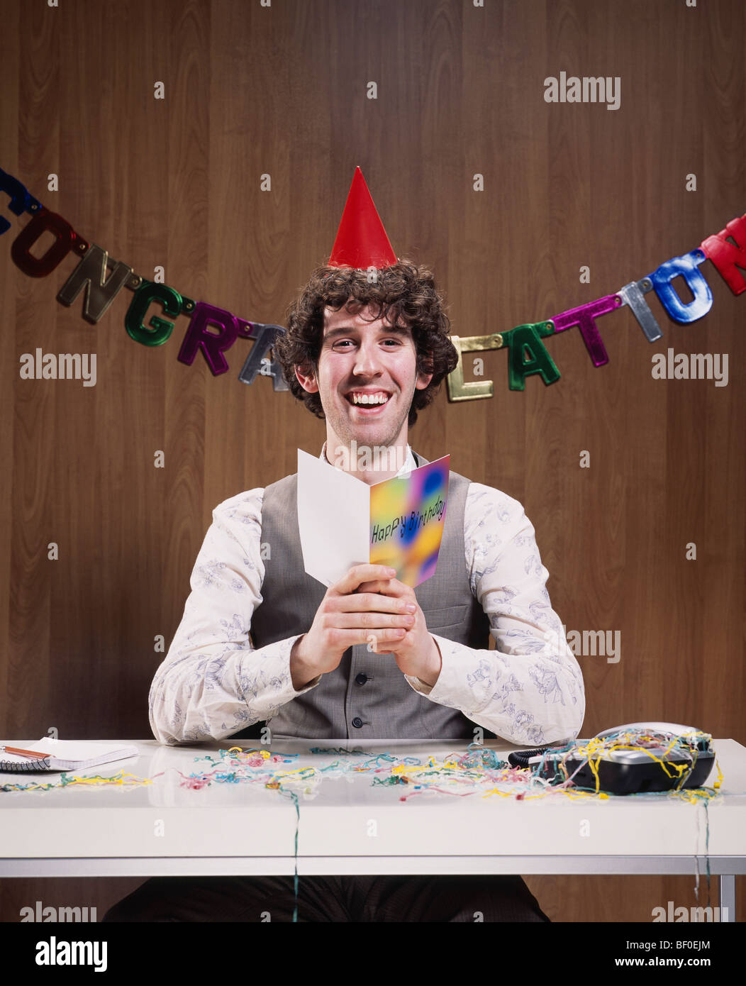 Businessman reading birthday card Stock Photo - Alamy