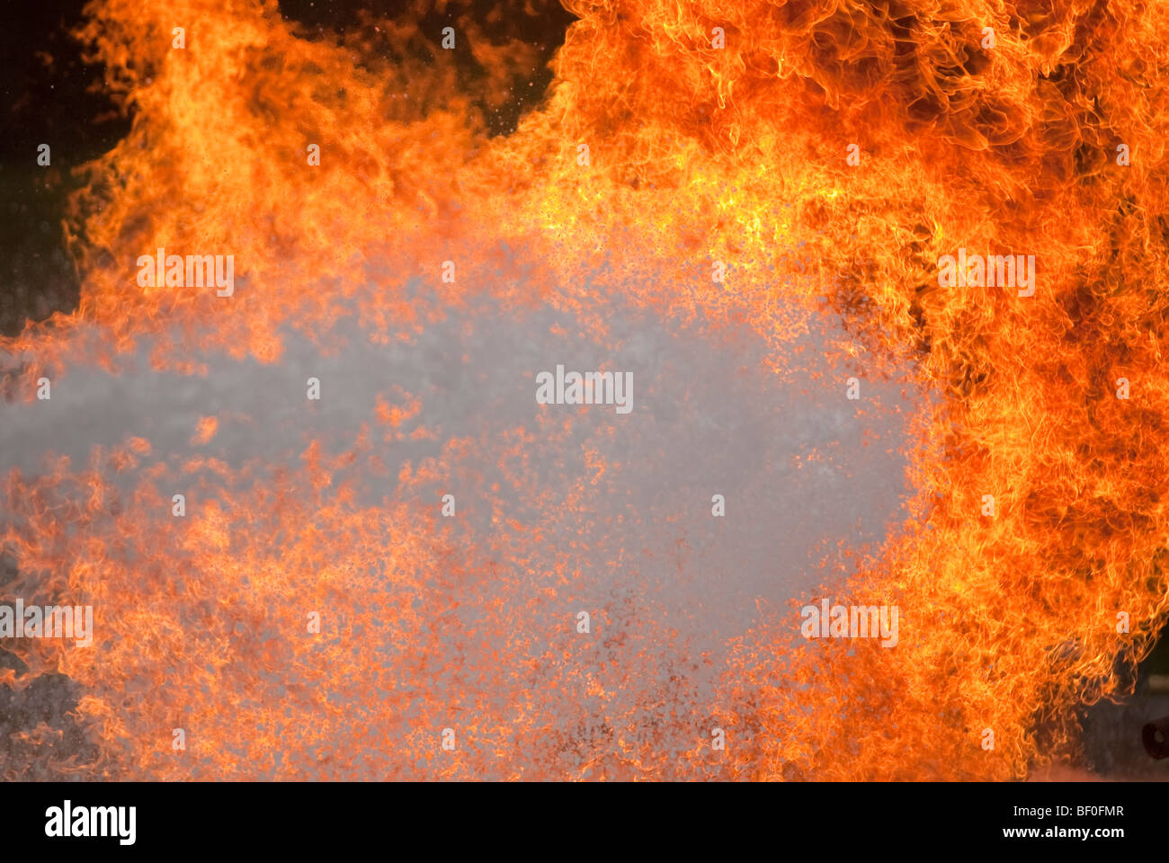 wall of flames from oil fire being tackled with foam branch Stock Photo ...