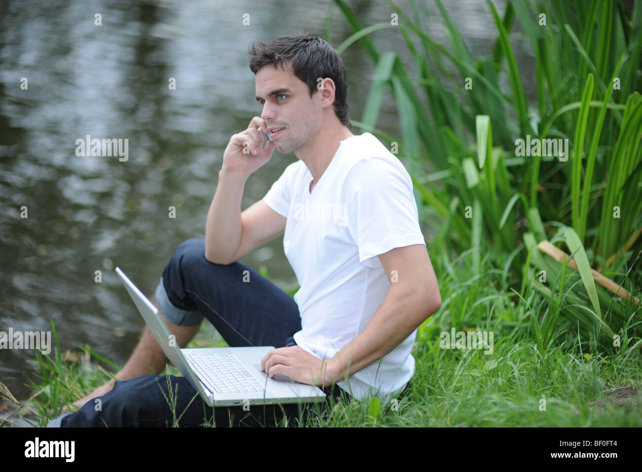 Young Man at Lake Stock Photo - Alamy