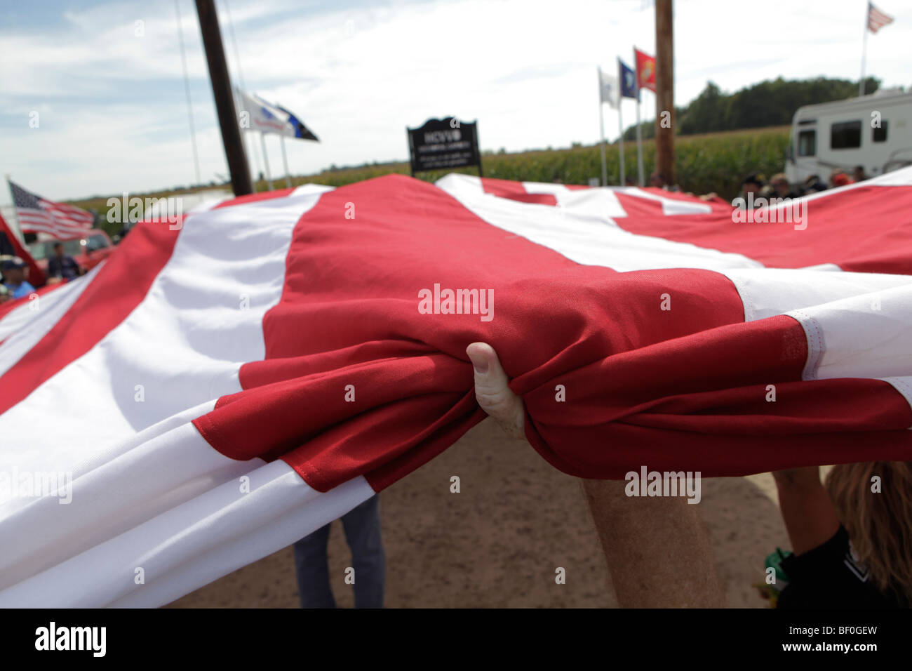 A group of Vietnam Veterans straighten a huge American flag during the ...