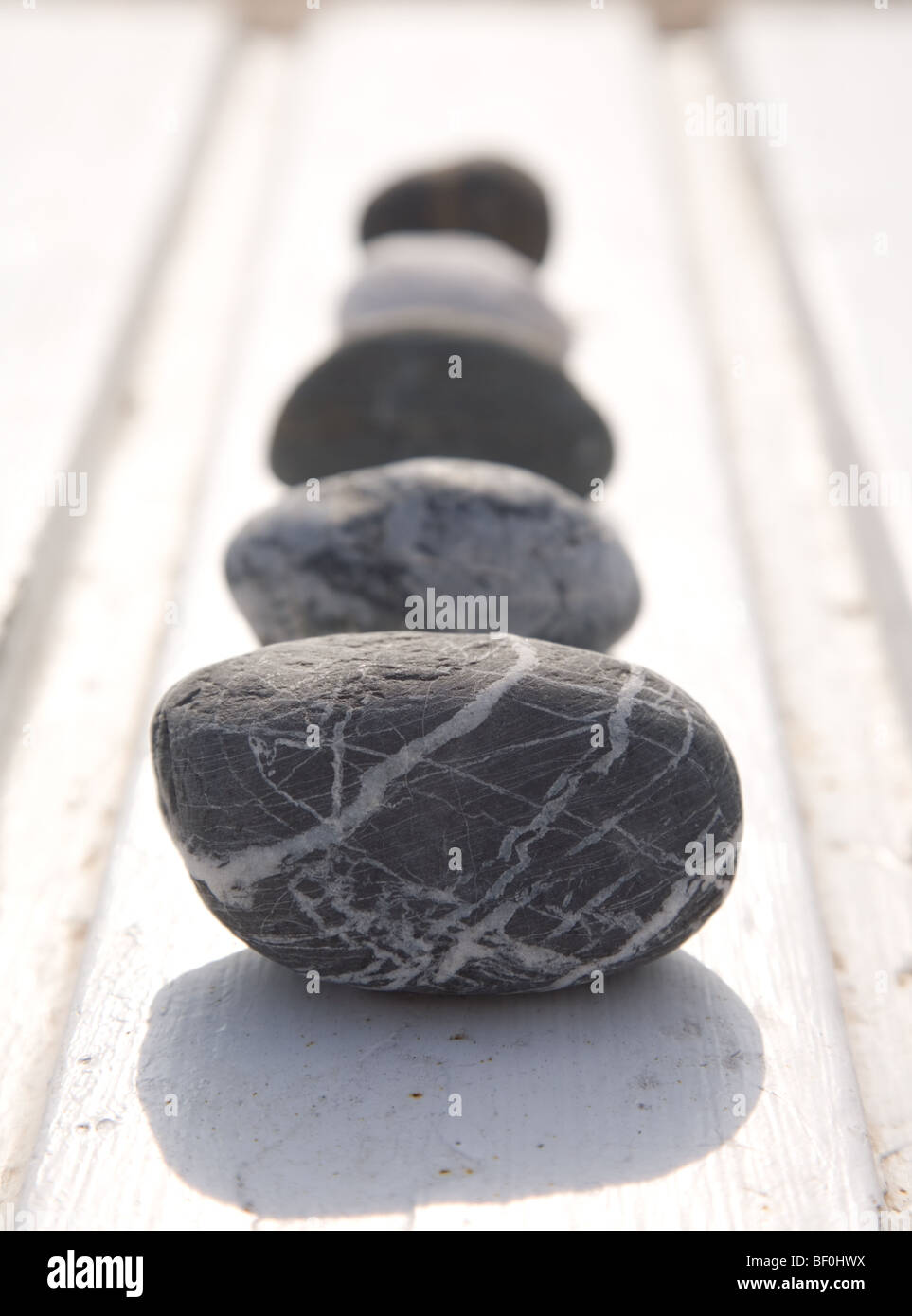 Stones in a row in the sunlight Stock Photo - Alamy