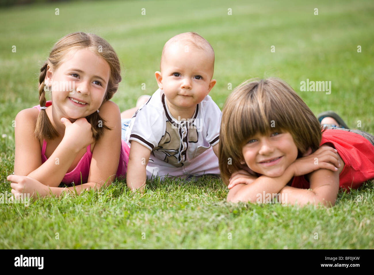 Little children on a meadow Stock Photo - Alamy