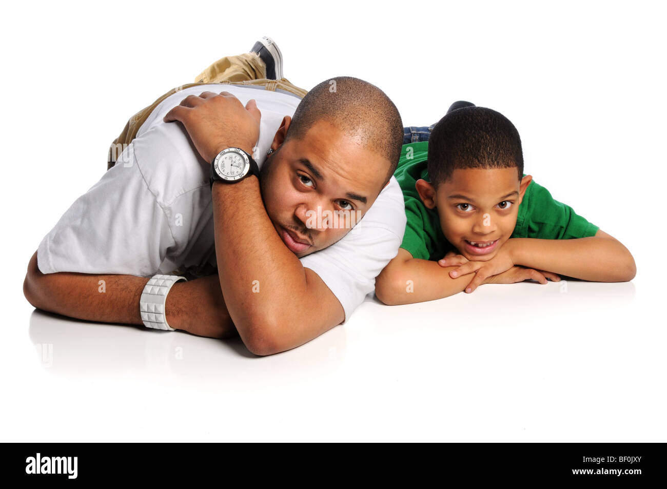 African American father and son laying on white floor Stock Photo - Alamy
