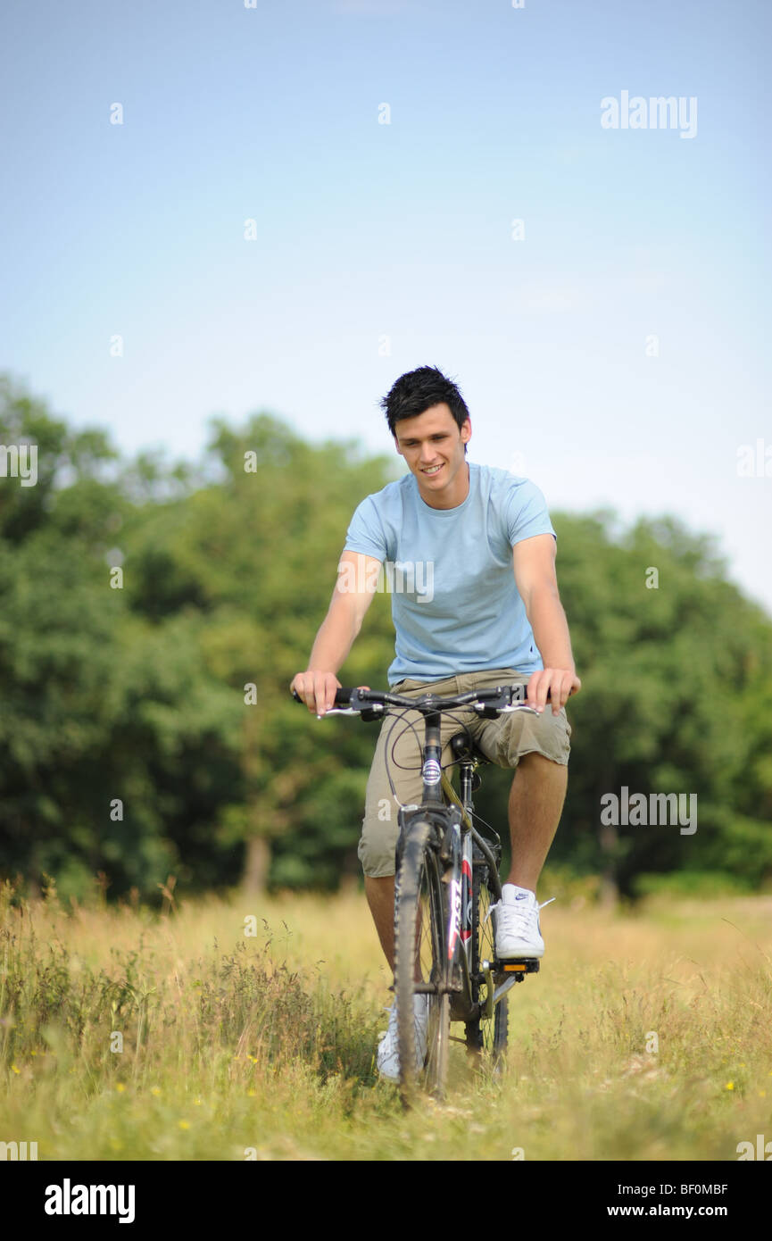 Ridding his bicycle hi-res stock photography and images - Alamy