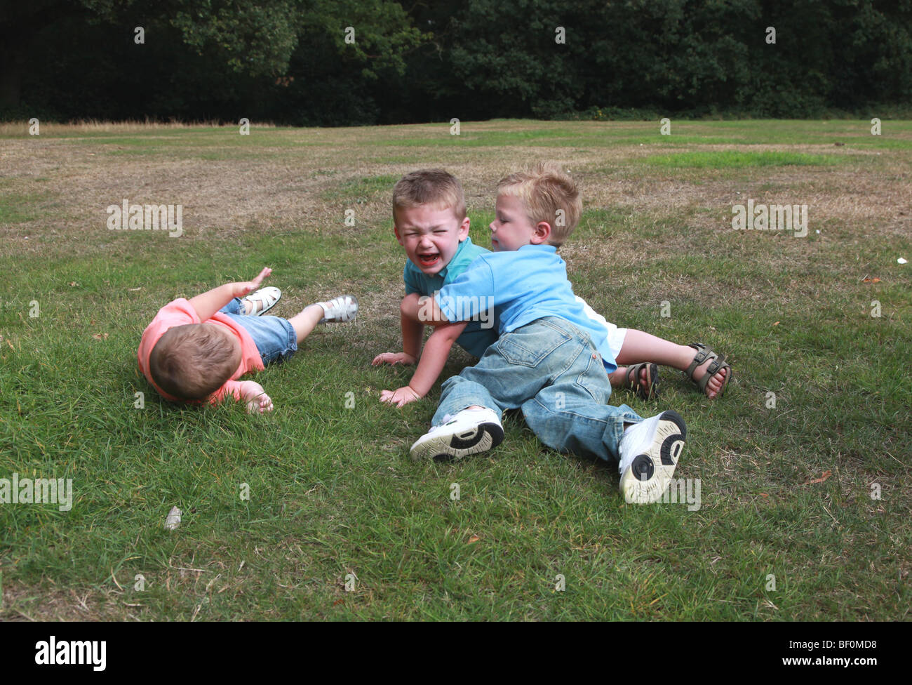 3 boys fighting Stock Photo - Alamy