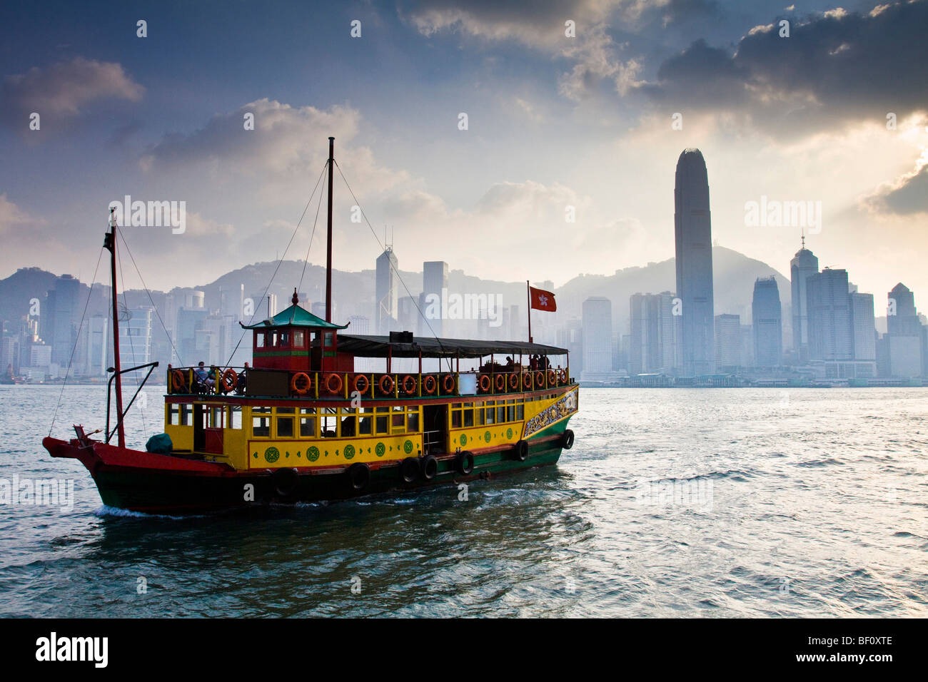 Hong Kong skyline with an old junk passenger ferry crossing Victoria ...