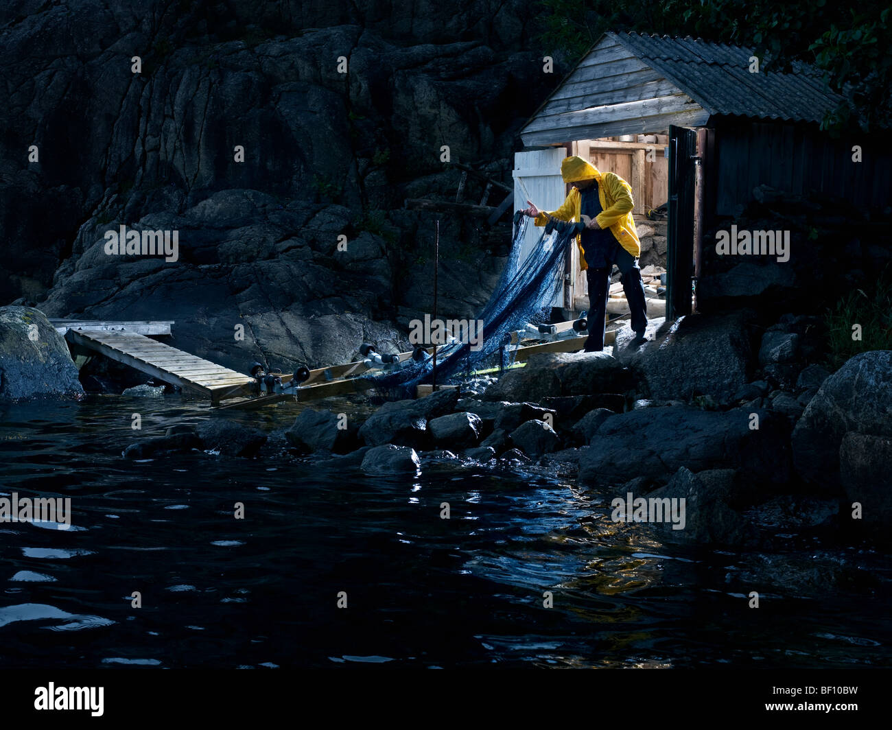 Fisherman pulling in net Stock Photo - Alamy