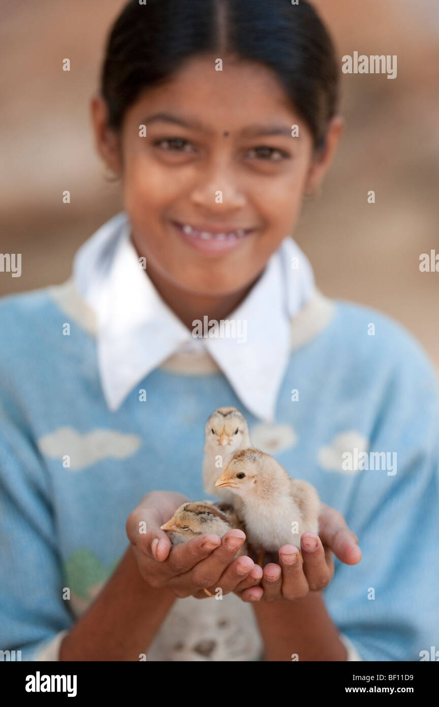 Young indian girl with chicks in the palm of her hands. Andhra Pradesh ...