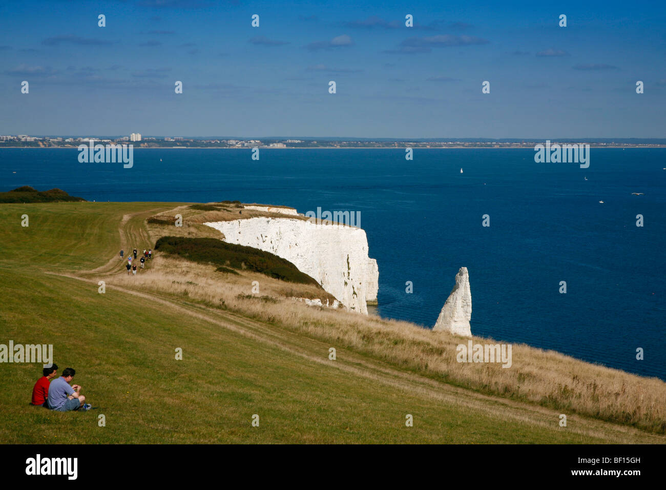 Walkers taking a rest beside the cliff top footpath above Old Harry ...