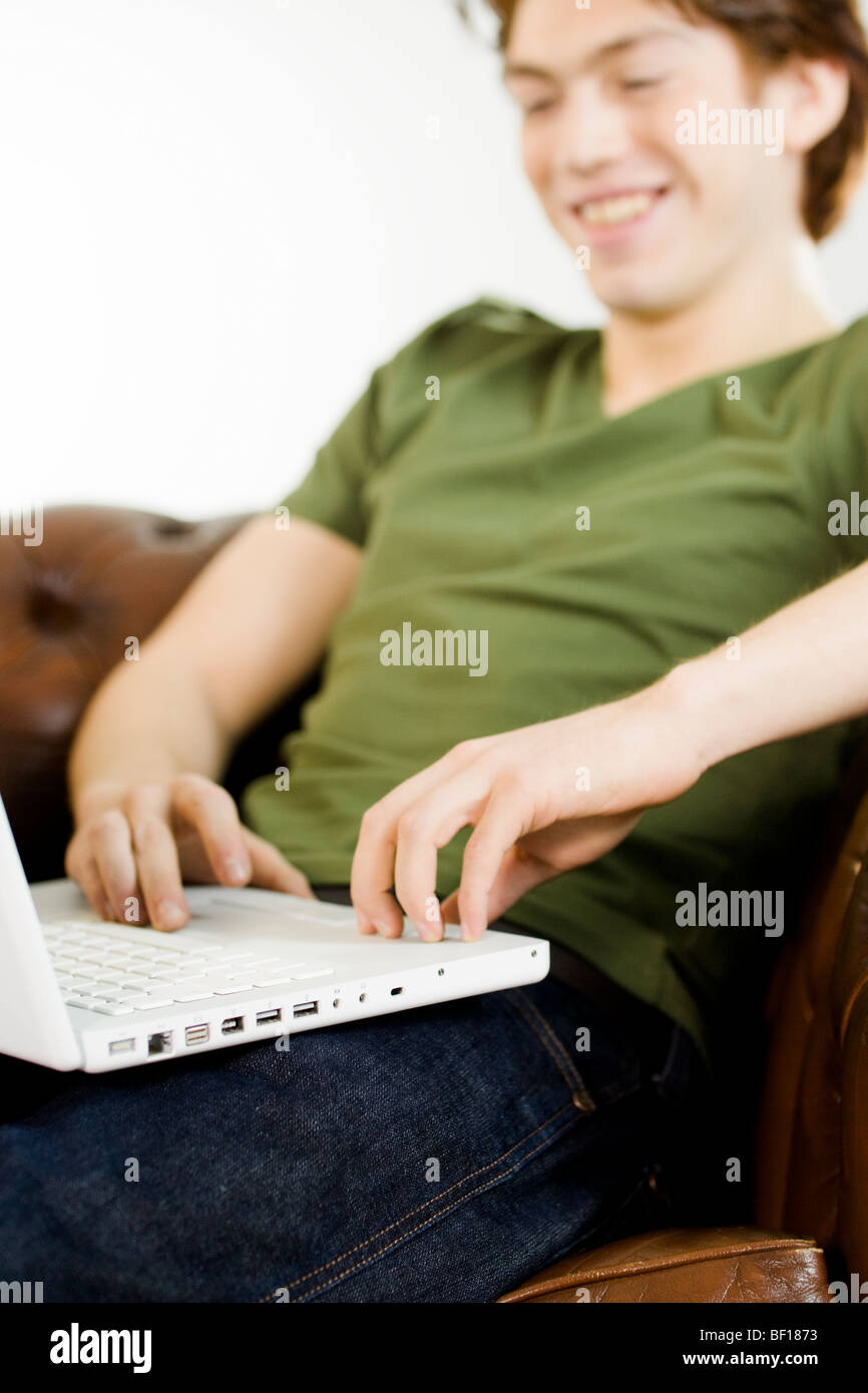 A teenage boy using a laptop Stock Photo - Alamy