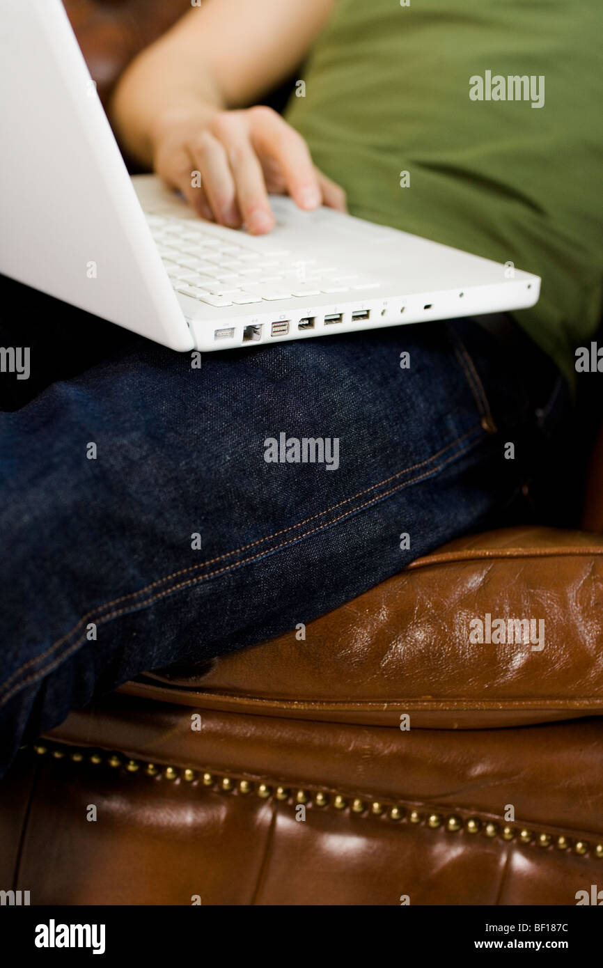 A teenage boy using a laptop Stock Photo - Alamy