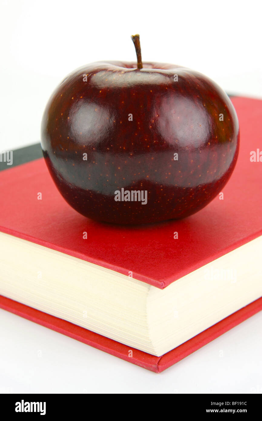 A red apple isolated on a white background with school books Stock ...