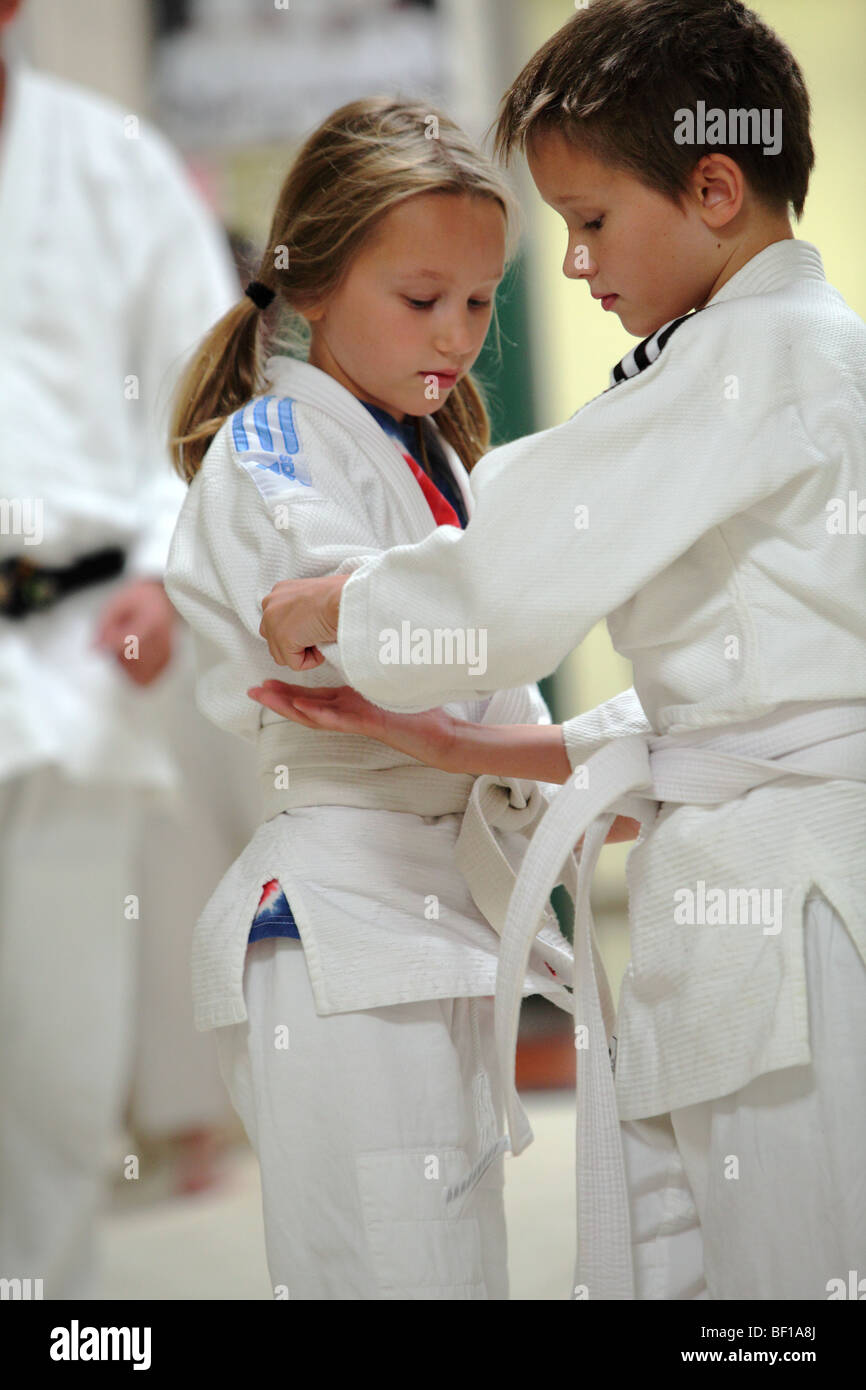 A judo class for kids and children with adults supervising the training ...