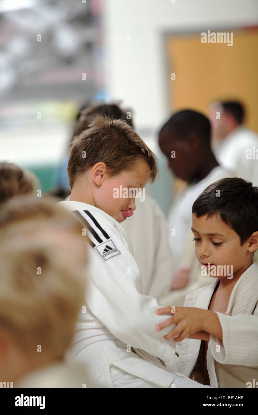 A judo class for kids and children with adults supervising the training ...