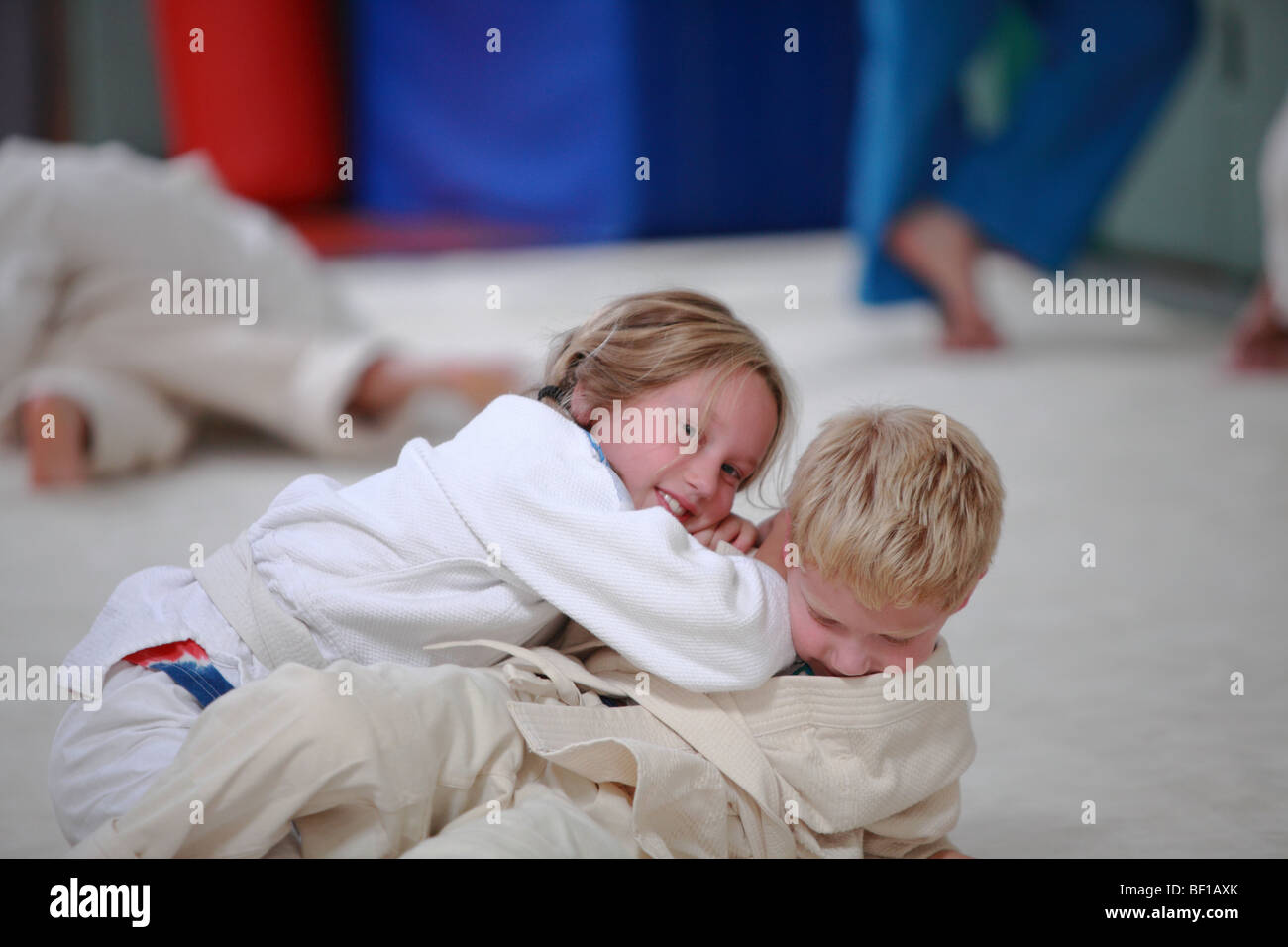 A judo class for kids and children with adults supervising the training ...