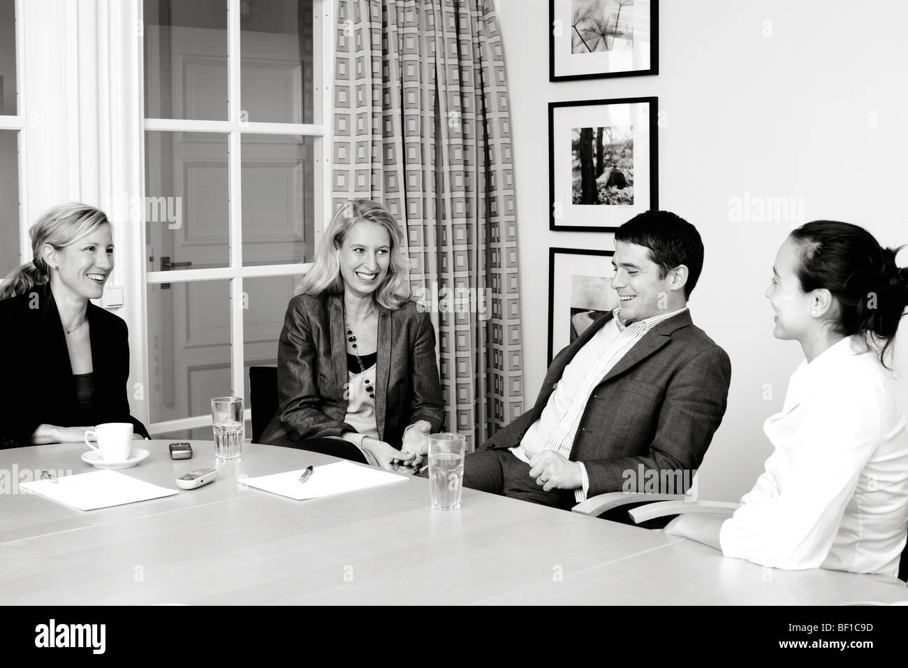 Four people sitting at a table, Sweden Stock Photo - Alamy