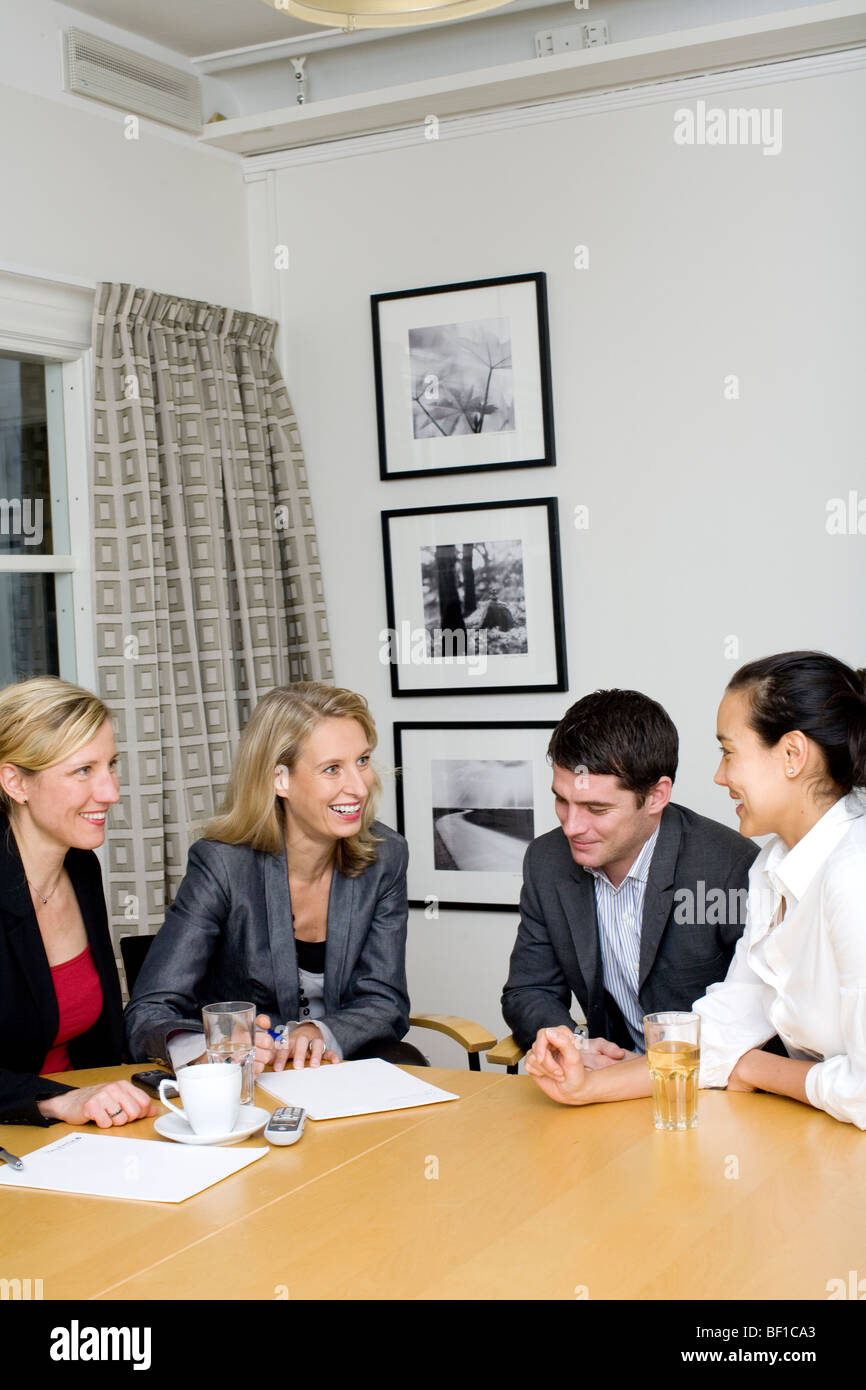 Four people sitting at a table, Sweden Stock Photo - Alamy
