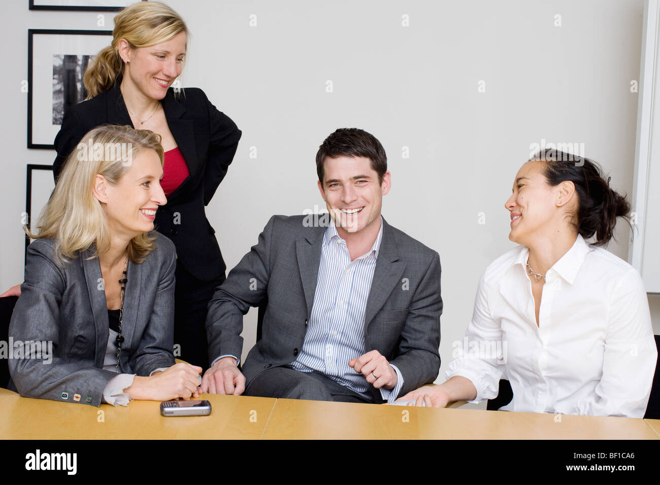 Four people sitting at a table, Sweden Stock Photo - Alamy
