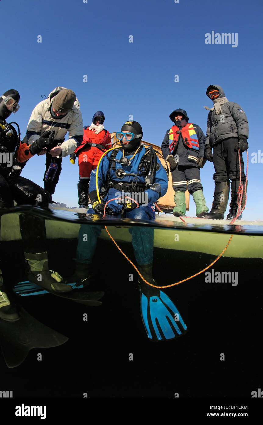 ice diving, split shot from ice divers and safty rope, White Sea ...