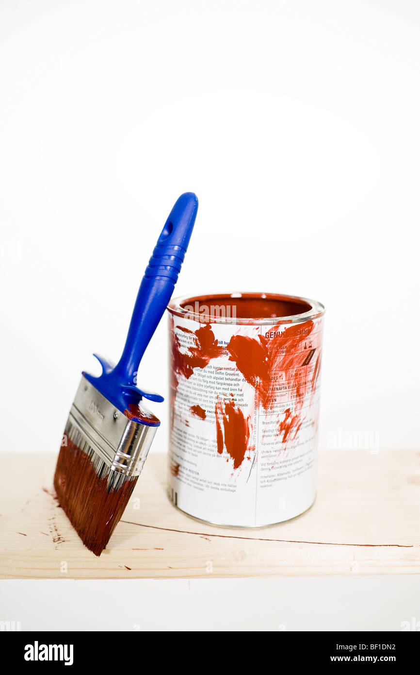 Paintbrush, red paint and a paint bottle Stock Photo - Alamy