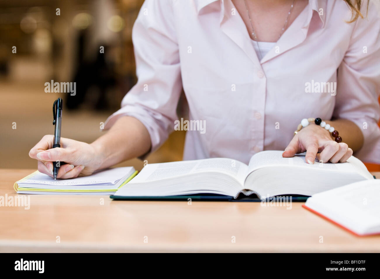 A female student studying in a library, Sweden Stock Photo - Alamy