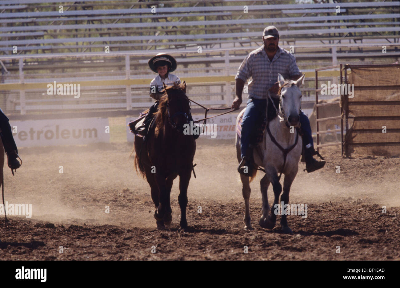 Father teaching young son mustering, rodeo, Queensland Australia Stock ...