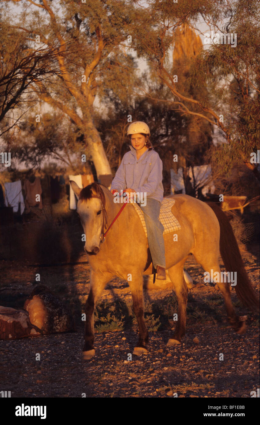Young teenage girl riding horse, outback desert, Queensland Australia ...