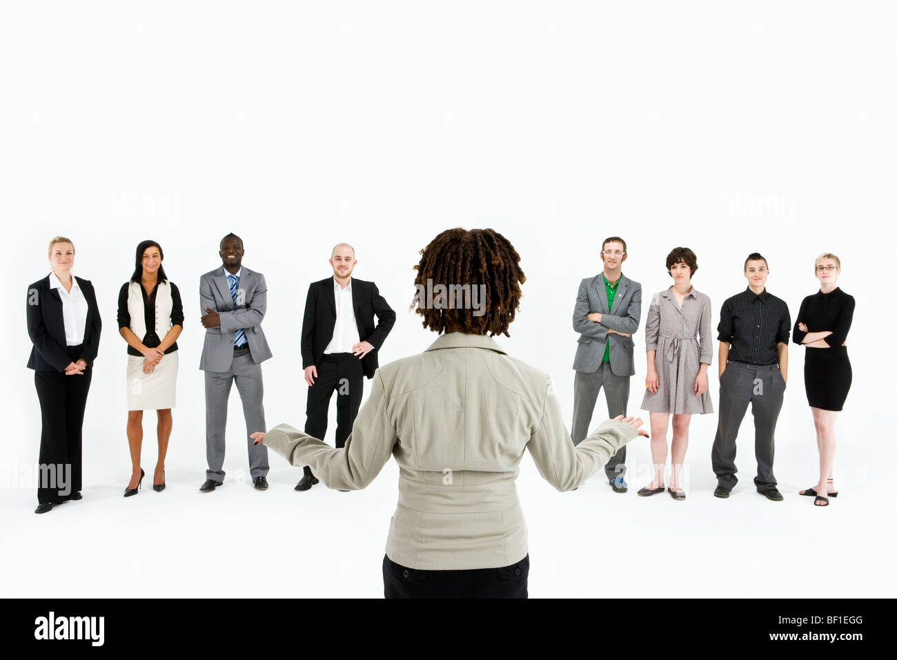 A woman standing in front of a row of business people Stock Photo - Alamy