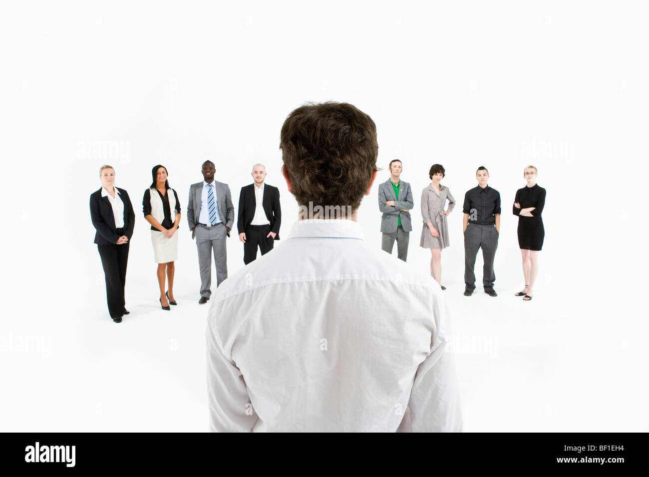 A man standing in front of a row of business people Stock Photo - Alamy