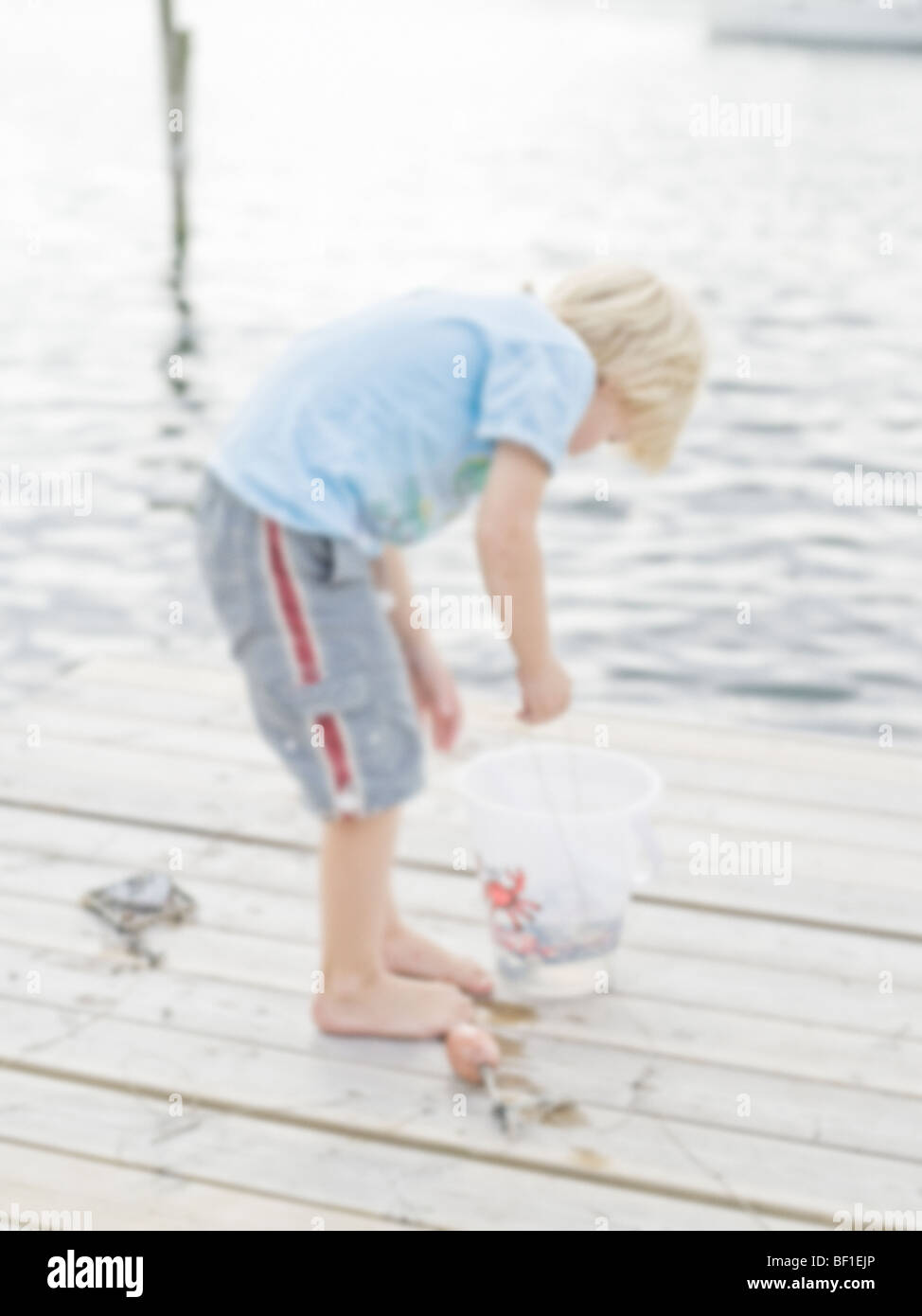 Scandinavian boy on a jetty, Sweden Stock Photo - Alamy
