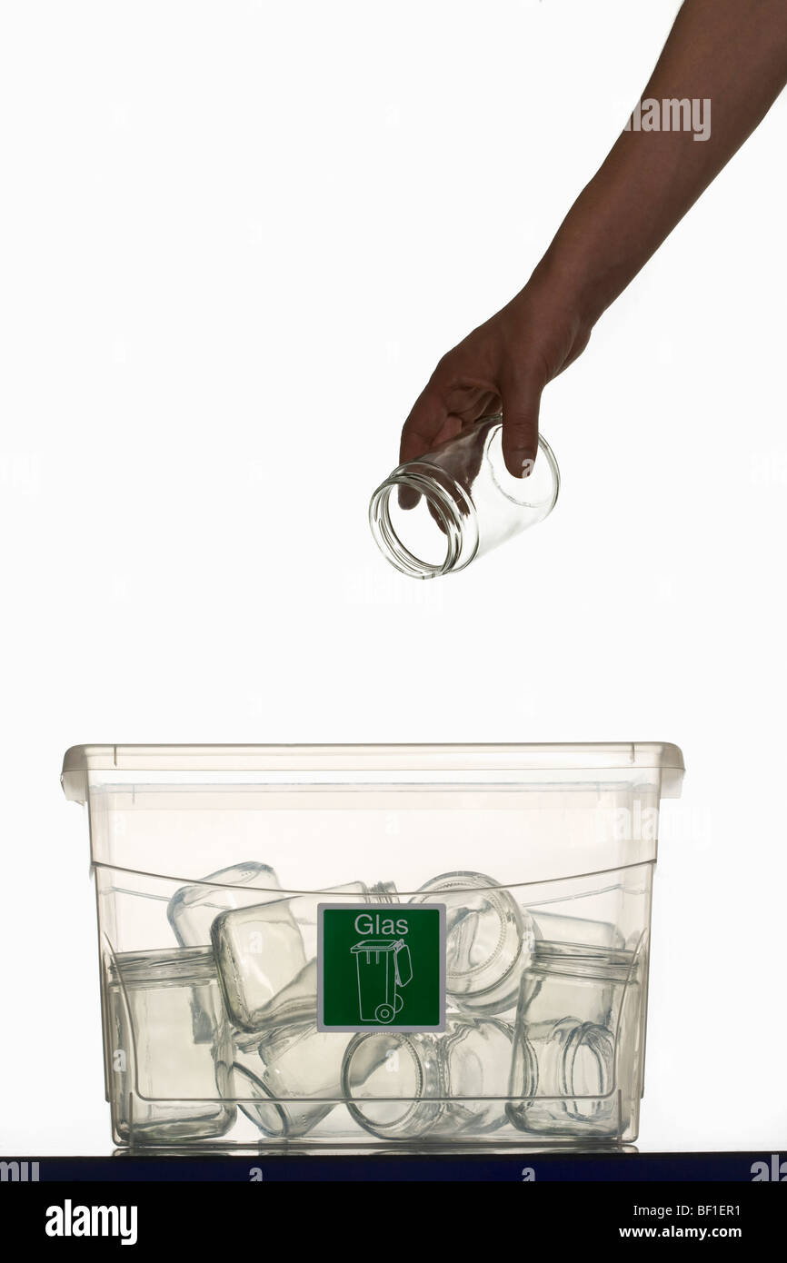 A human hand throwing a glass jar in a recycling bin Stock Photo - Alamy