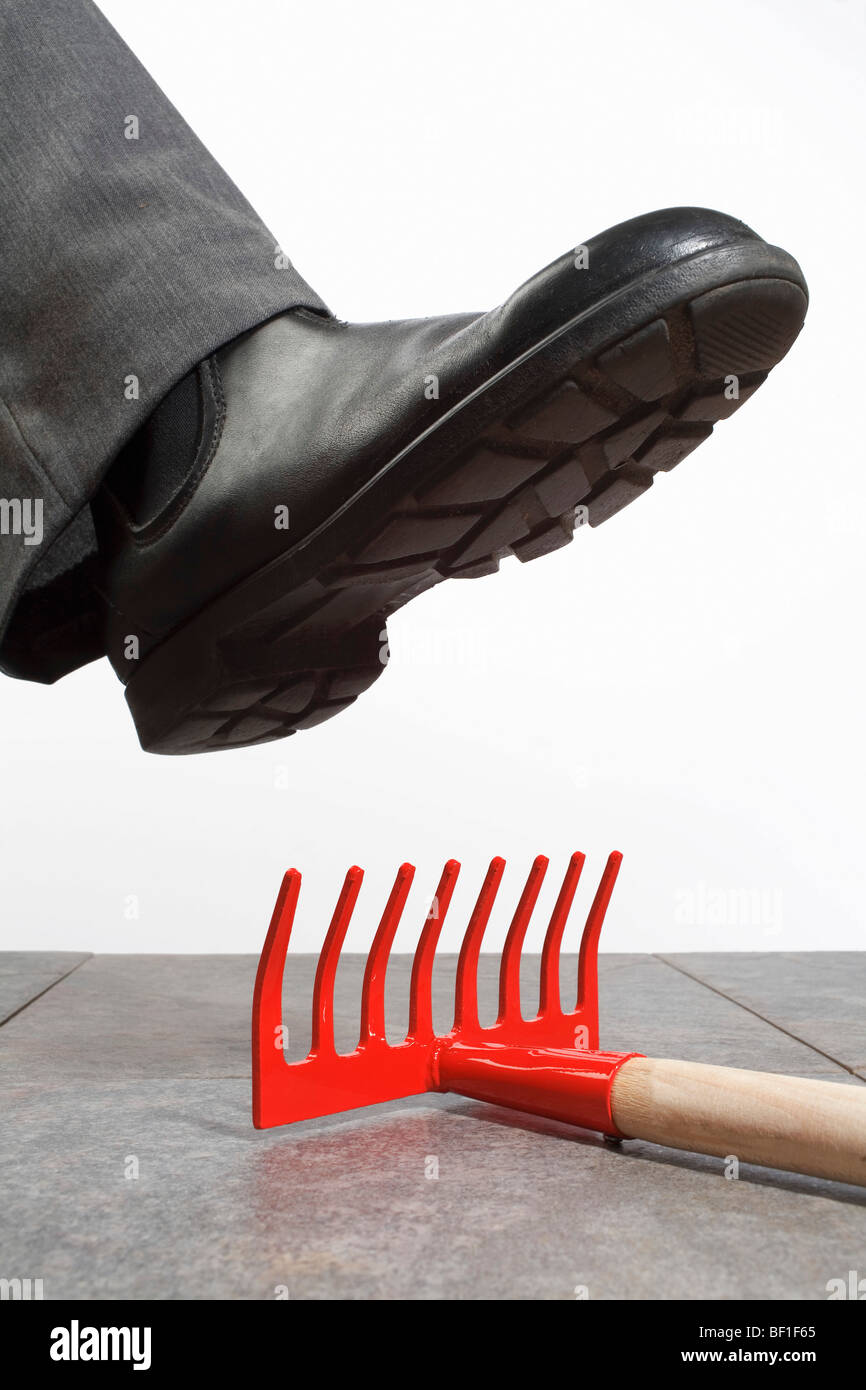 A foot above a rake Stock Photo - Alamy