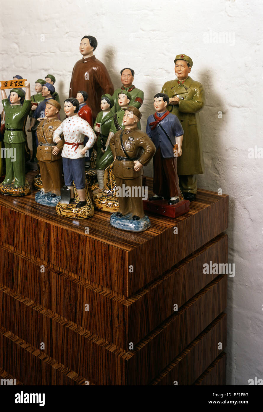 Communist ceramic figurines arranged on a wooden cabinet Stock Photo ...