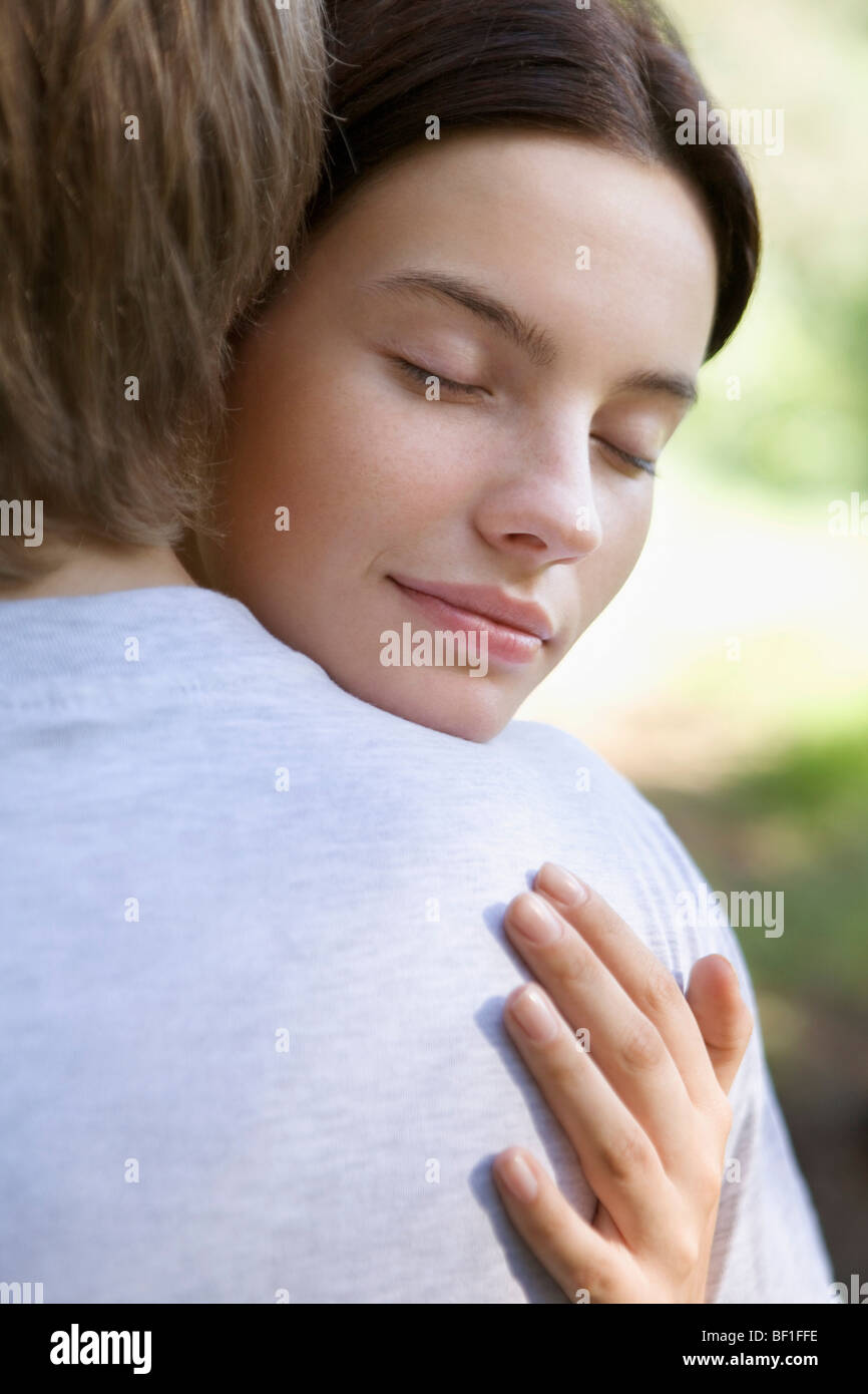 A young couple embracing Stock Photo - Alamy