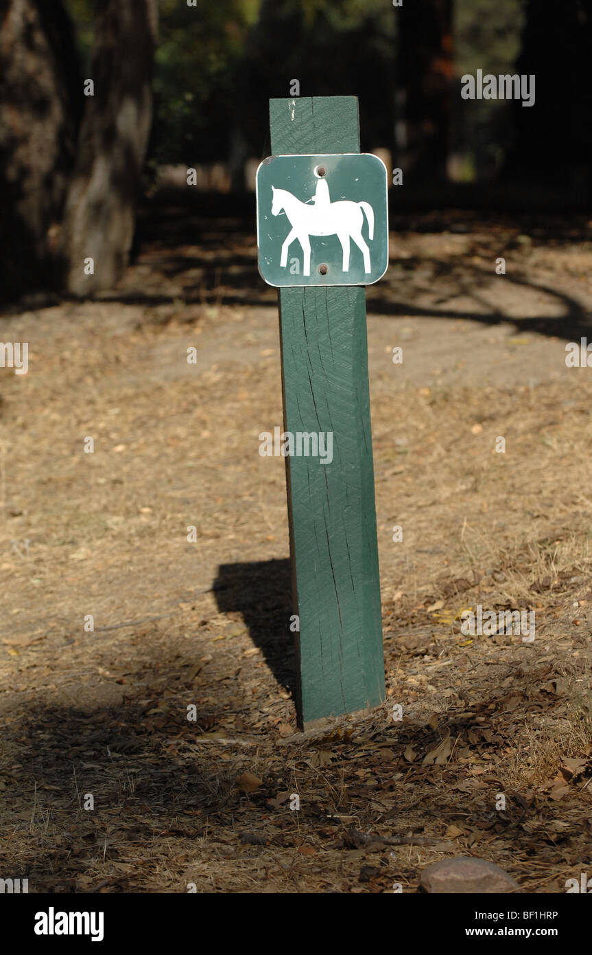 sign with a picture of a person riding a horse designates a horse trail ...