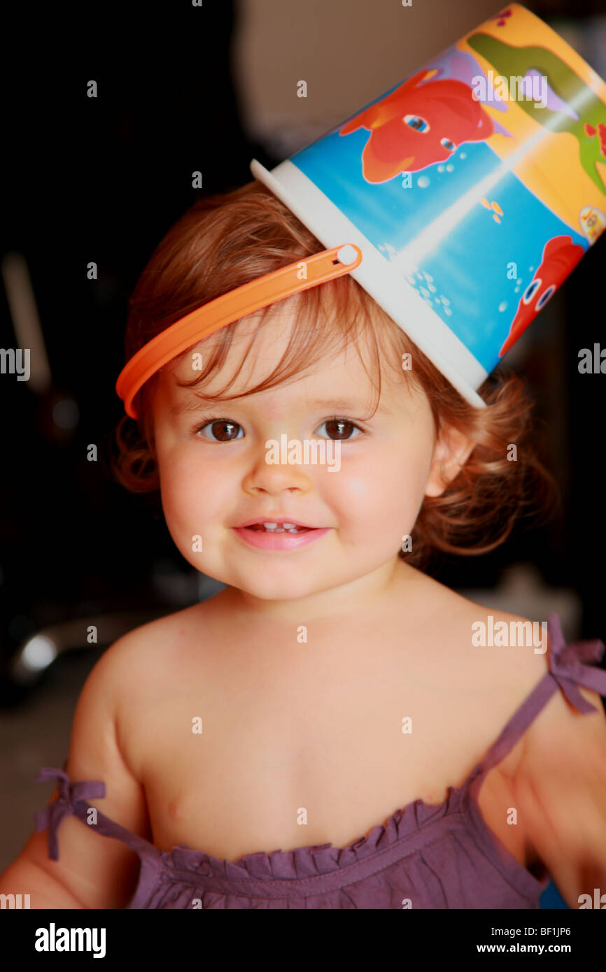Child with a bucket on head hi-res stock photography and images - Alamy