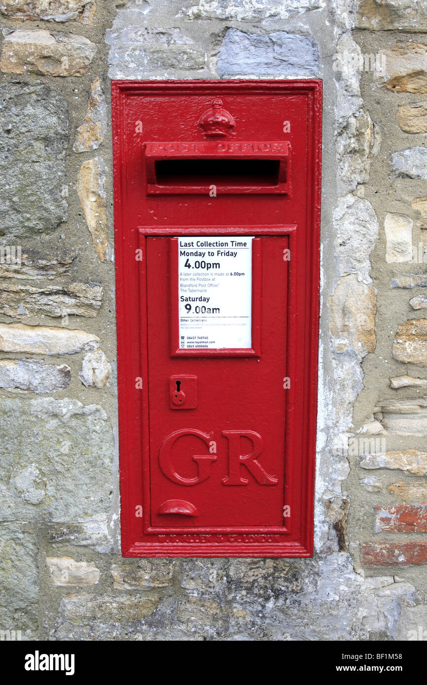 An English Red Royal Mail letter box cemented into a wall Stock Photo ...