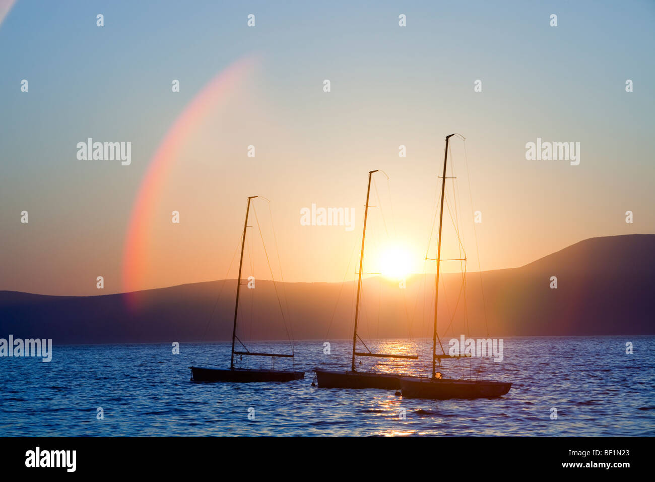 A rainbow surrounding boats on the turkish coast at Teos Stock Photo ...