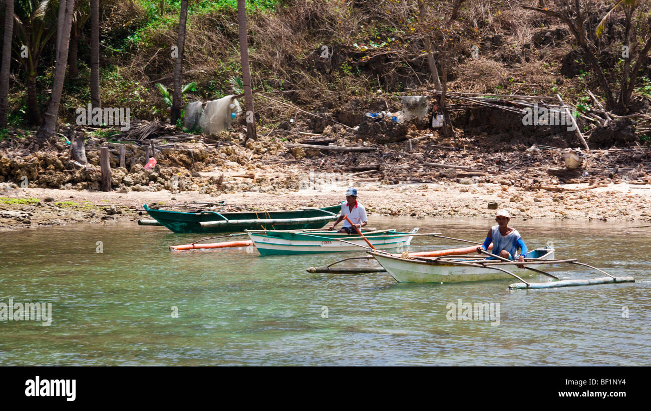 Filipino men paddling traditional canoes (banca). Guimaras Island ...