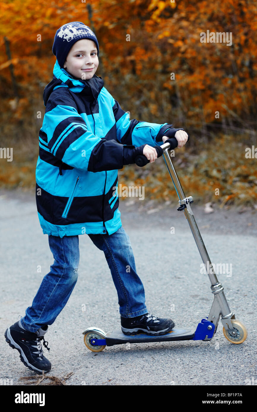 Boy driving a scooter Stock Photo - Alamy Boy driving a scooter Stock Photo - Alamy