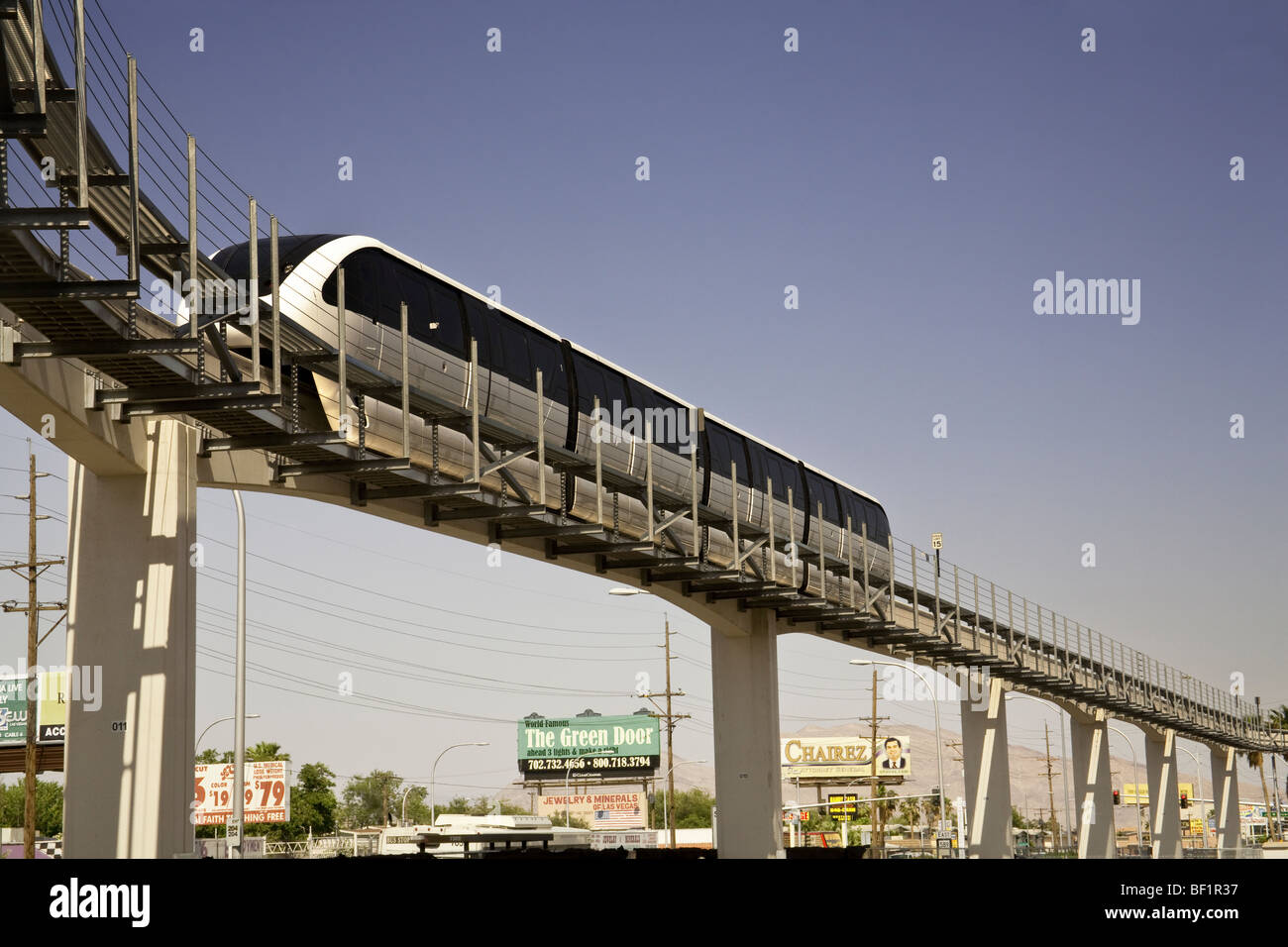 Looking upward to a train traveling on the monorail line held up on ...