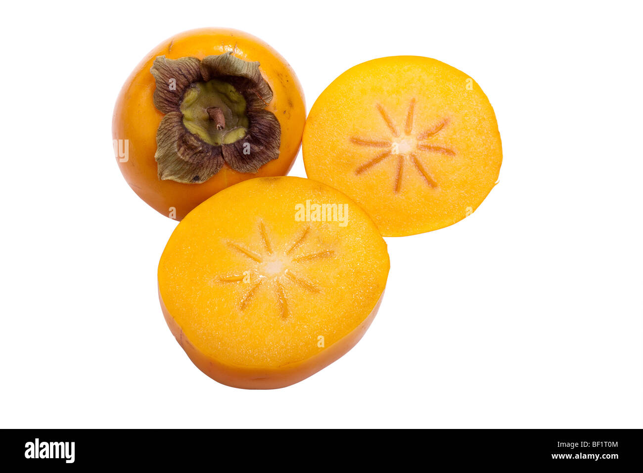 Two sharon fruit one whole one sliced isolated against white background ...