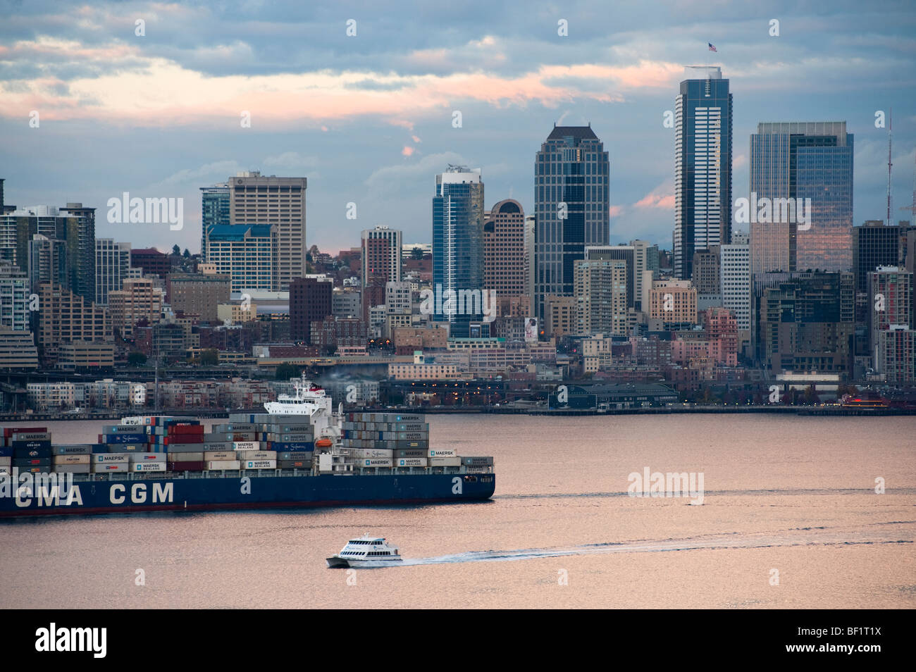 At sunset, a container ship sails out of Elliott Bay and the Seattle ...