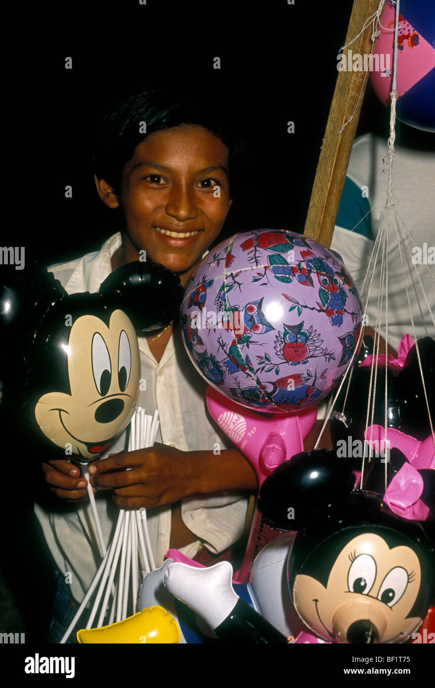 1 one Mexican boy balloon vendor selling balloons at fiesta in Cancun ...